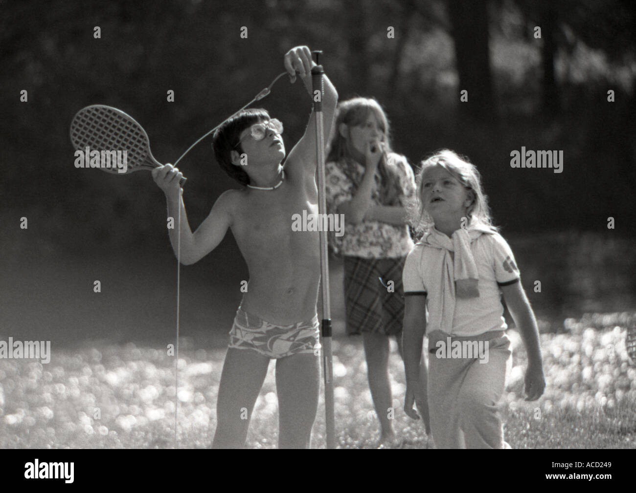 children playing swingball game Stock Photo - Alamy