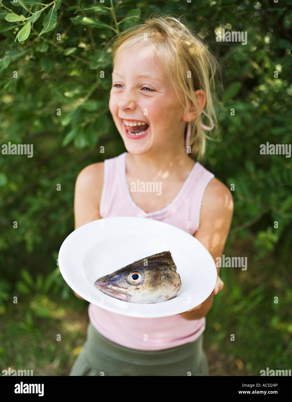 A girl with the head of a fish on a plate Stock Photo - Alamy