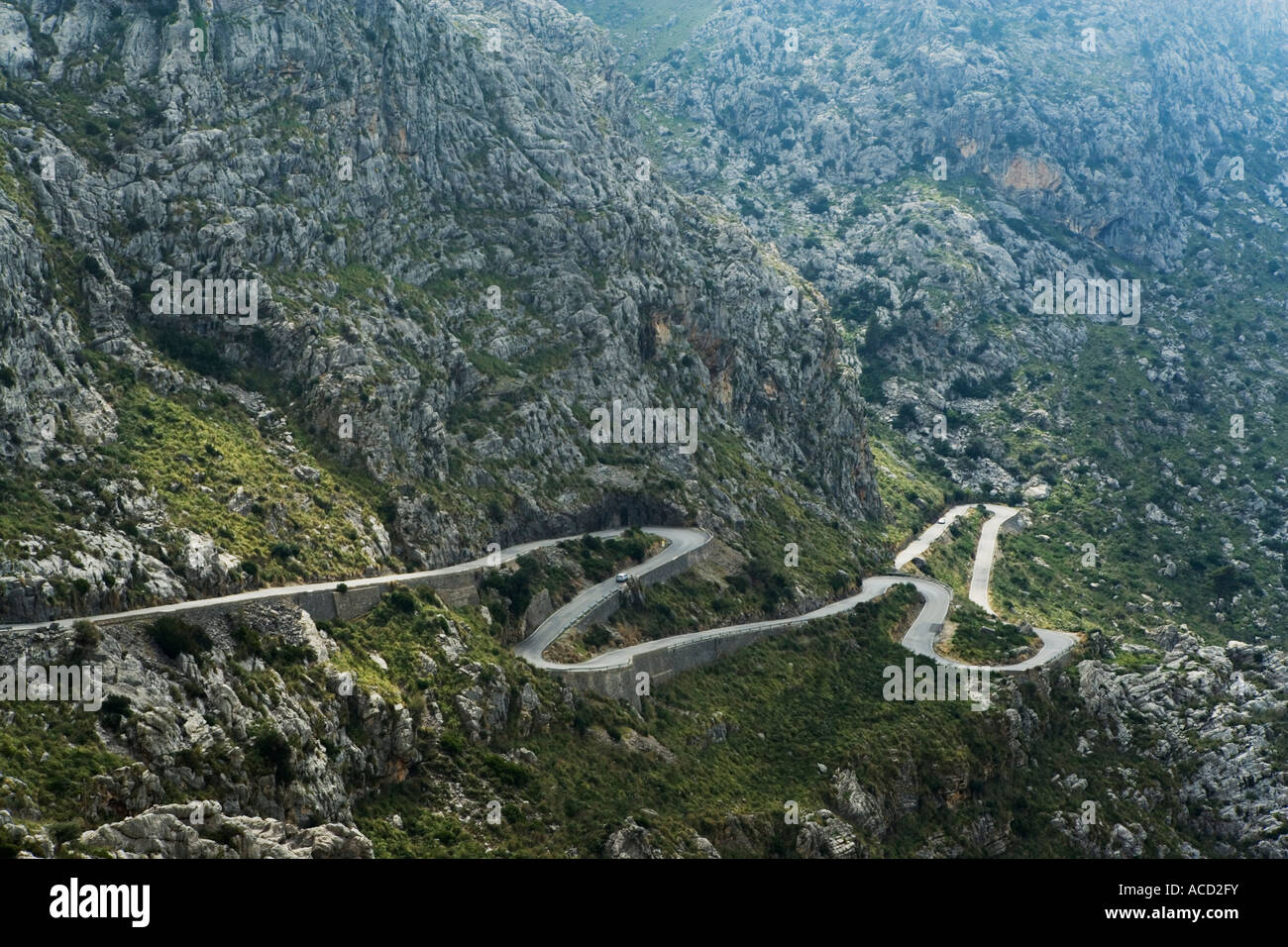 Twisting road in a mountain landscape Stock Photo - Alamy