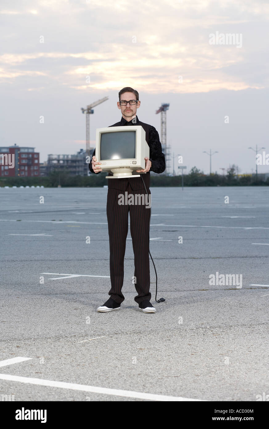 A man carrying a computer screen Stock Photo - Alamy