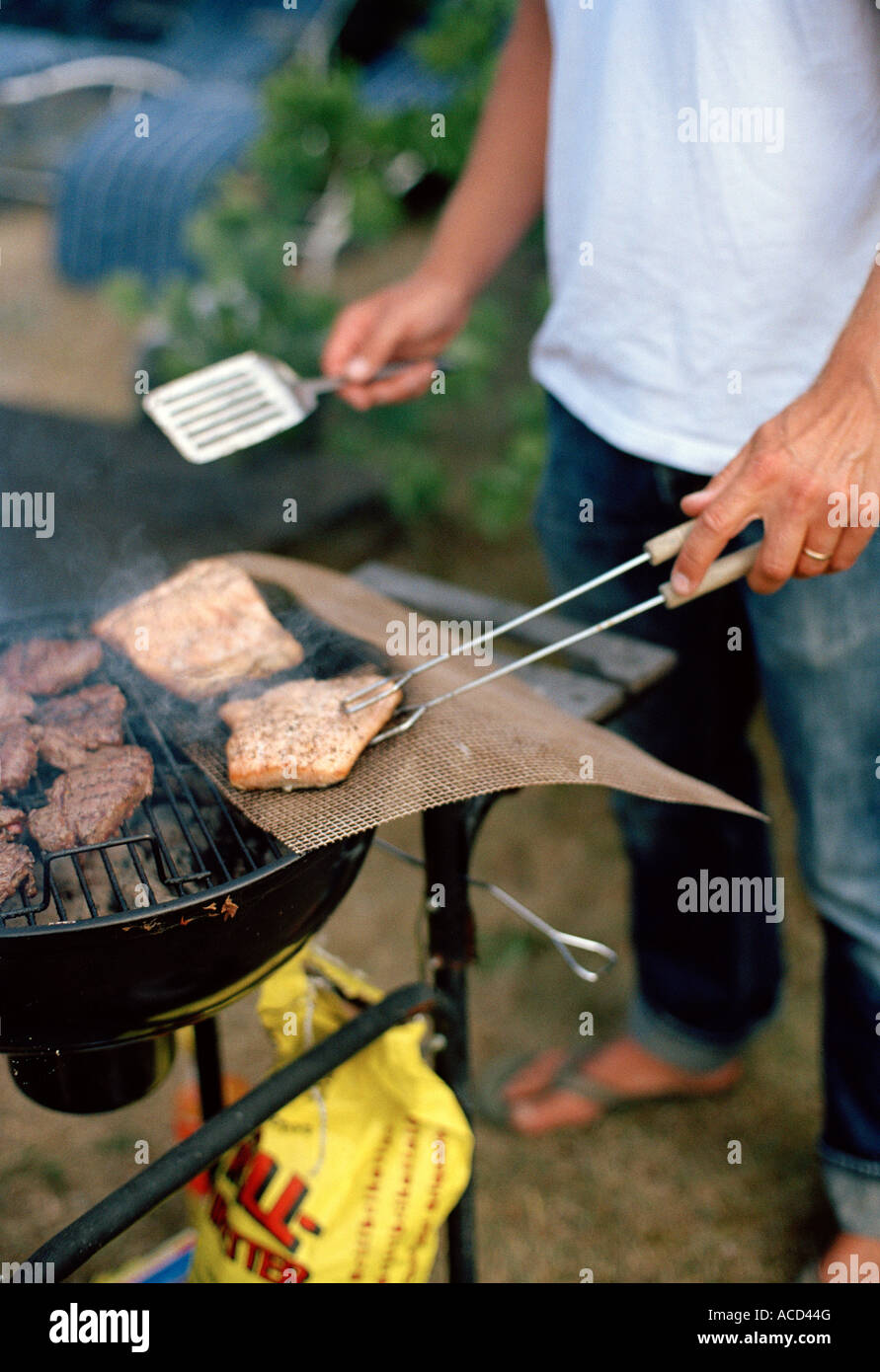 A man grilling meat Stock Photo - Alamy