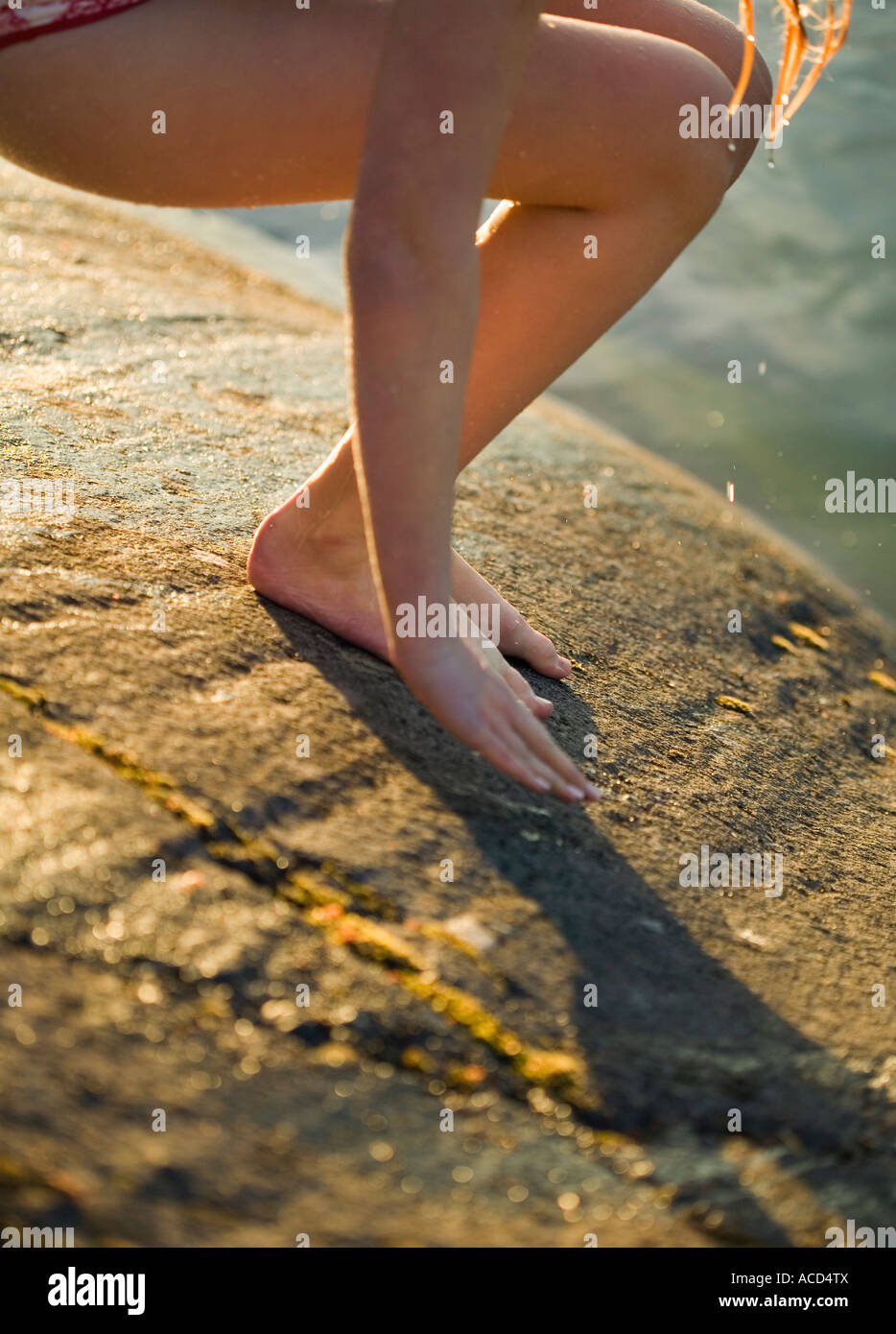 Girl sitting barefoot on rock hi-res stock photography and images - Alamy