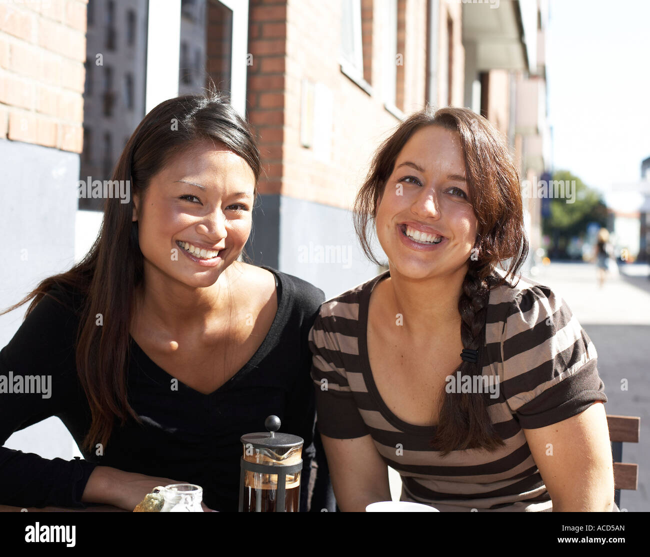 Two teenage girls drinking coffee Stock Photo - Alamy