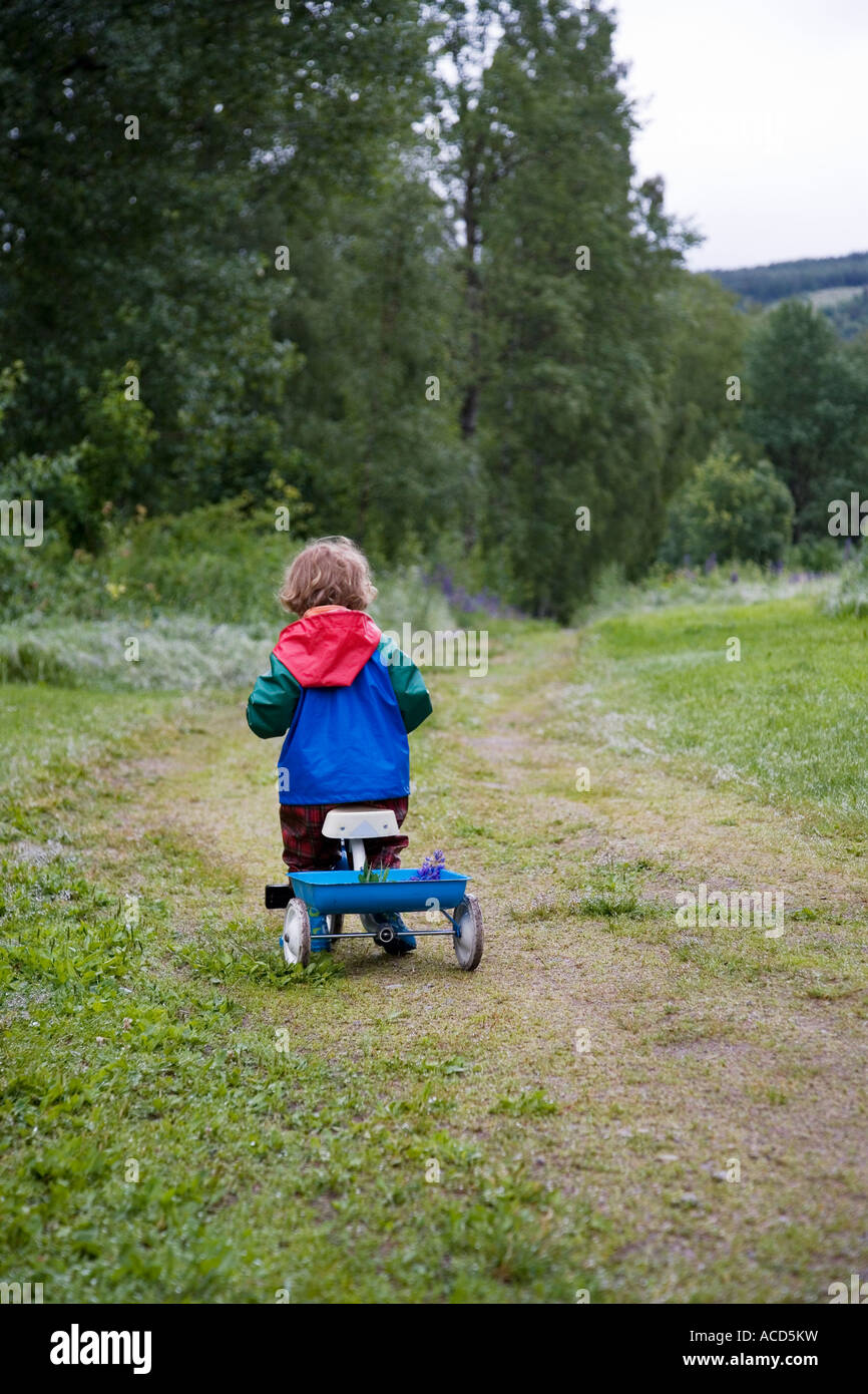 Child on tricycle hi-res stock photography and images - Alamy