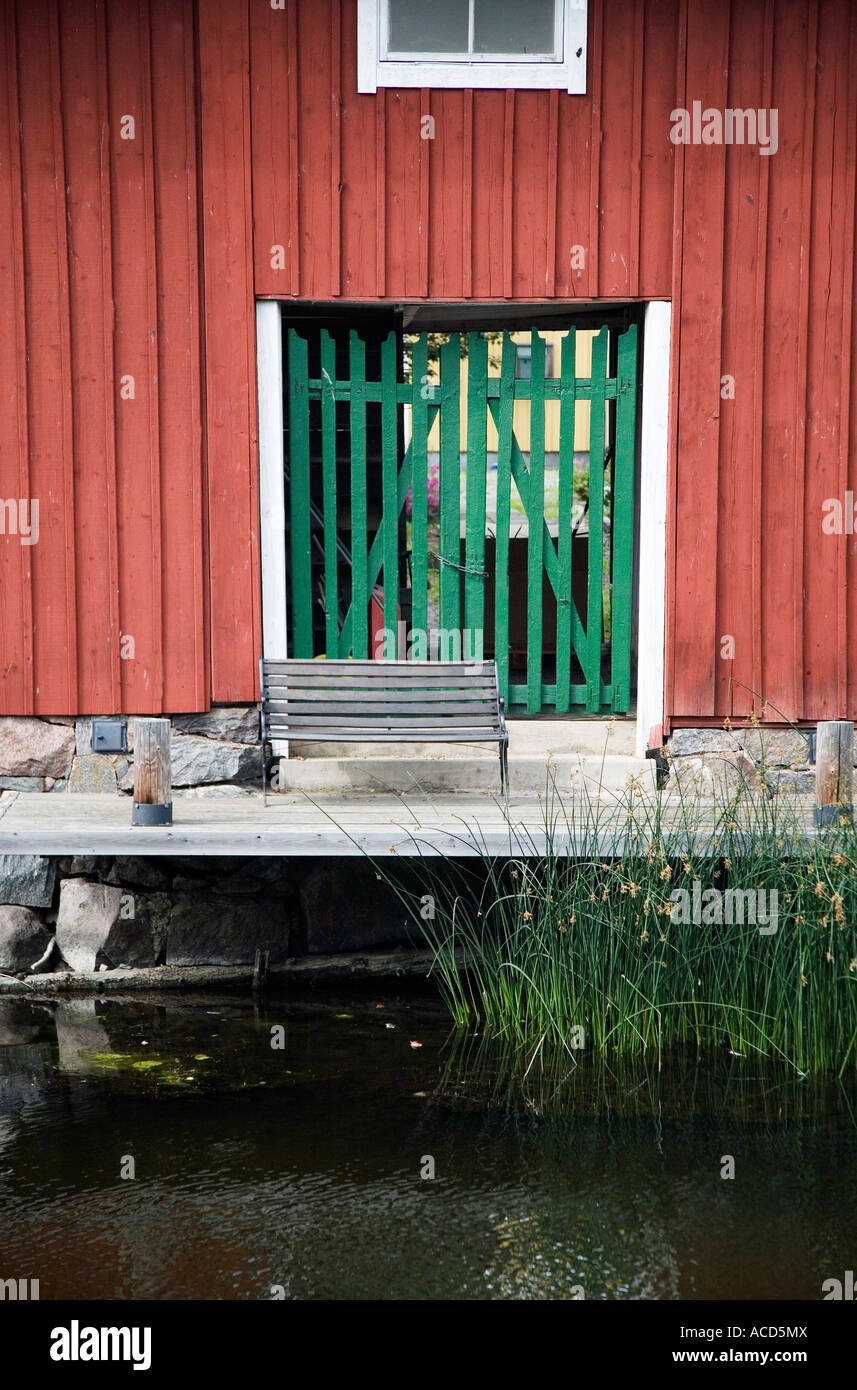 A house with a gate to a lake Stock Photo - Alamy