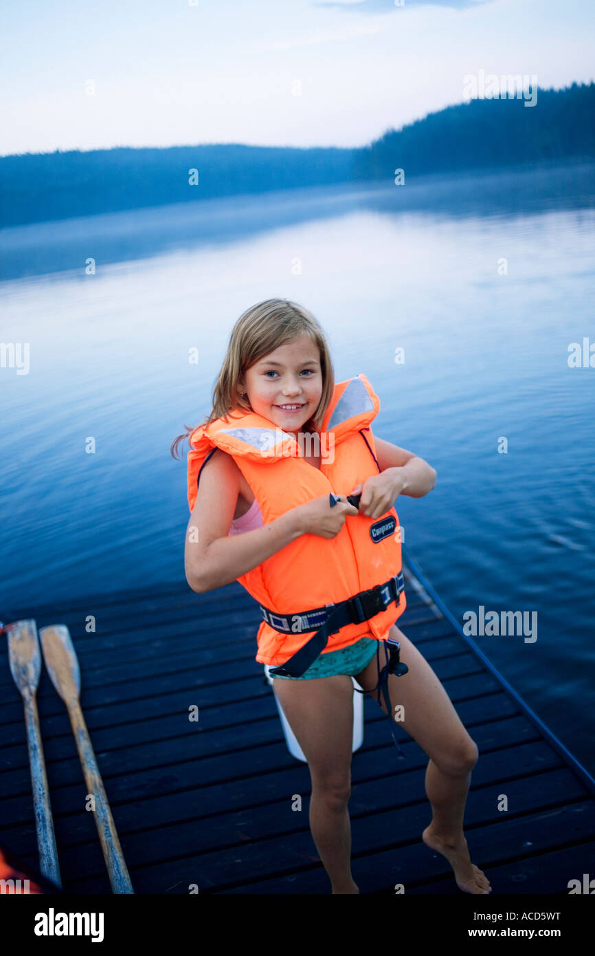 A smiling girl wearing a life jacket Stock Photo - Alamy