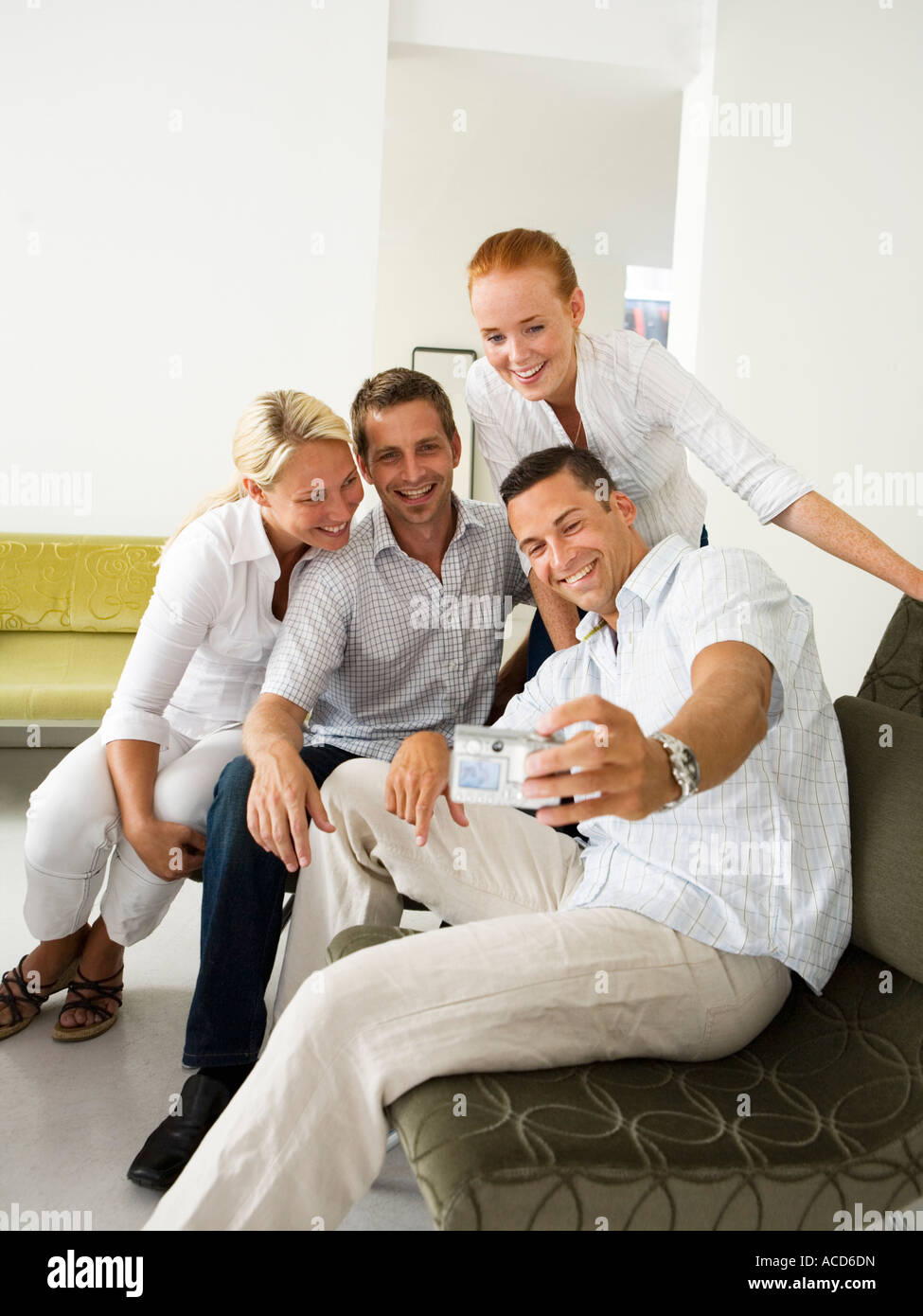 Four persons taking their picture in an office Stock Photo - Alamy