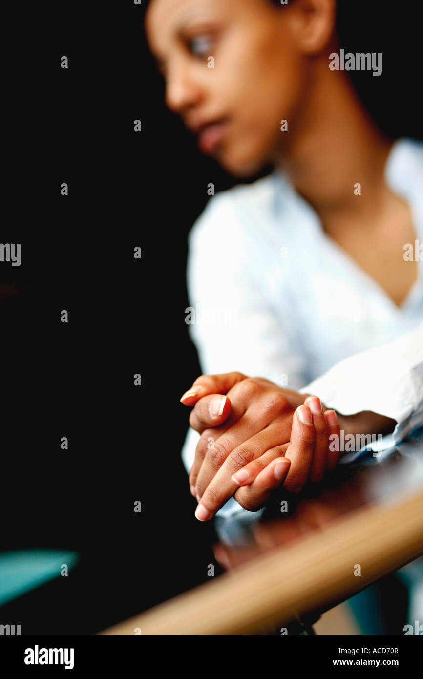 A young woman with folded hands Stock Photo - Alamy