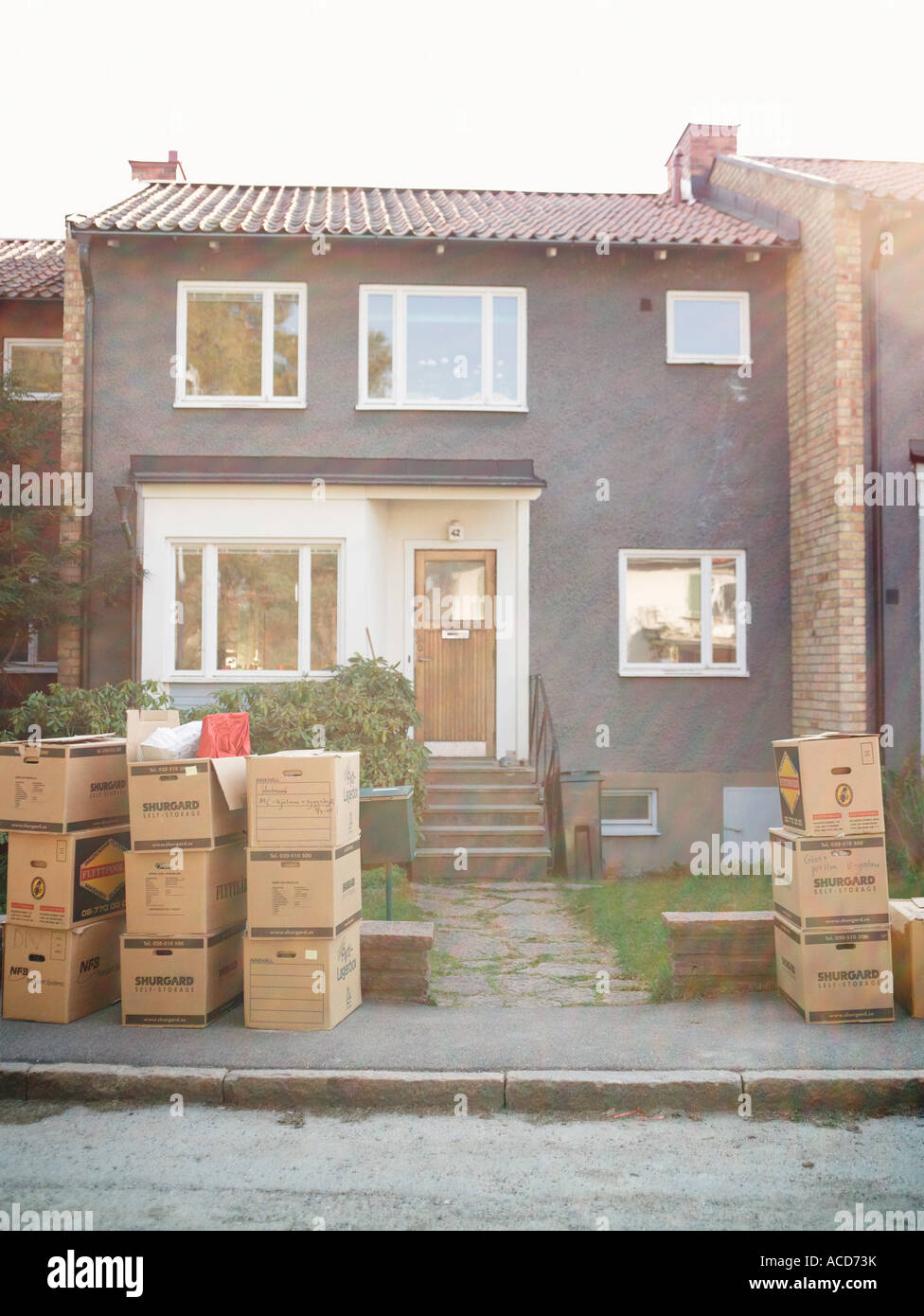Moving boxes outside a house Stock Photo - Alamy