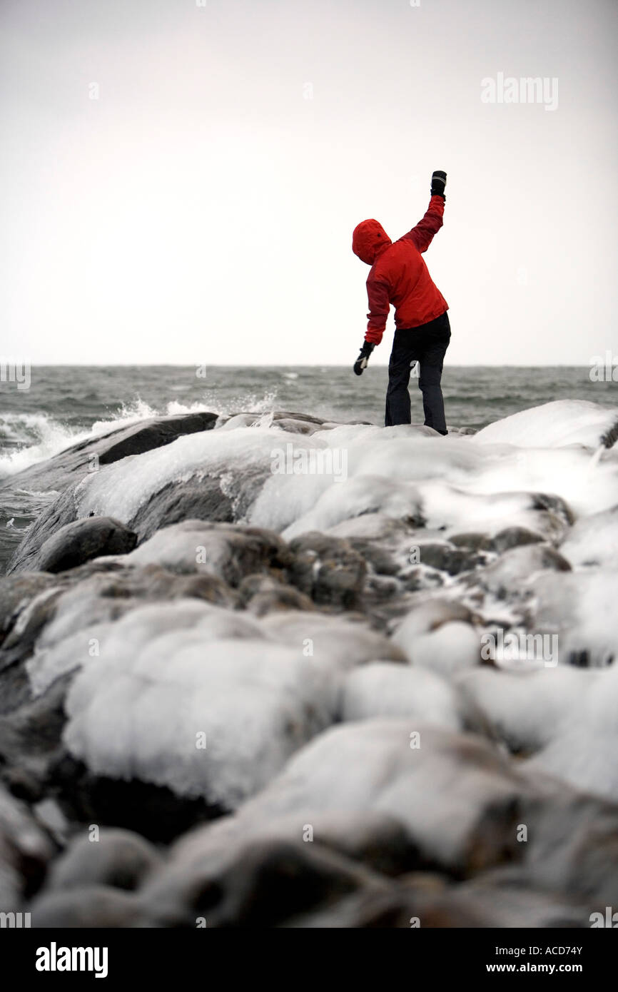 A woman on rocks covered in ice Stock Photo - Alamy