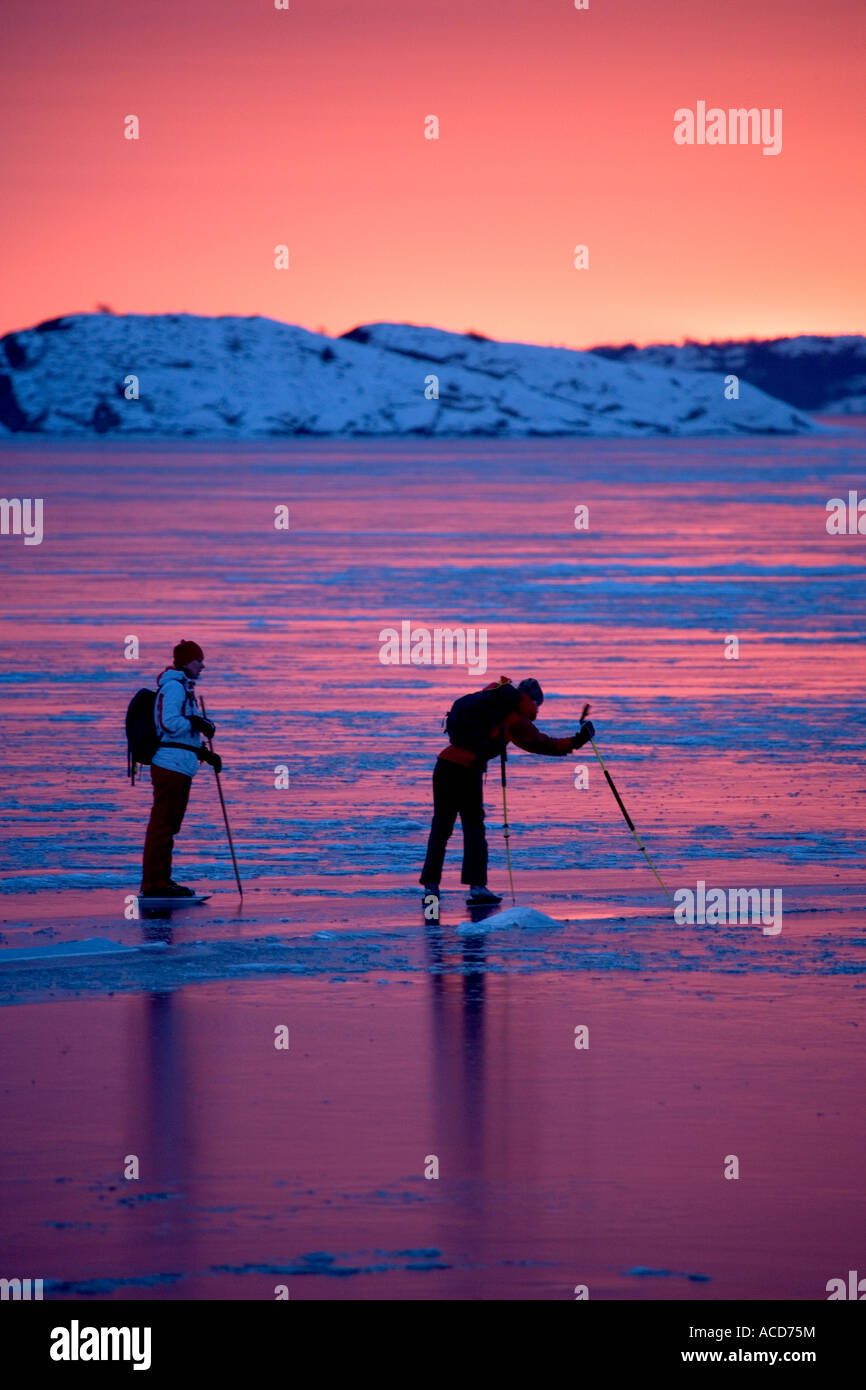 Skaters on calm ice Stock Photo - Alamy