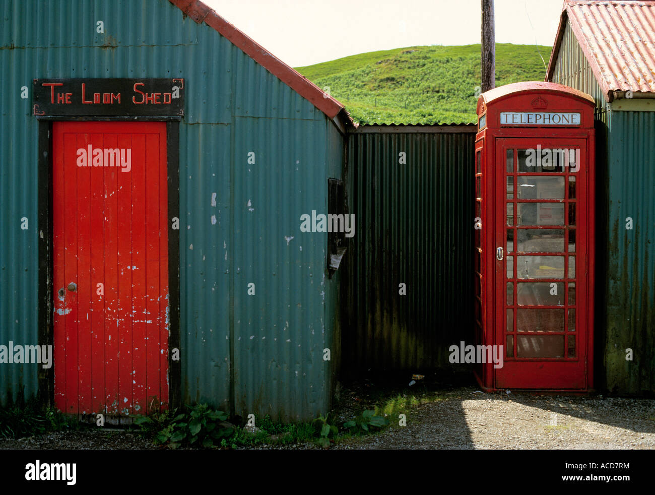 Red telephone box near red door on blue corrugated iron shed, Scotland ...