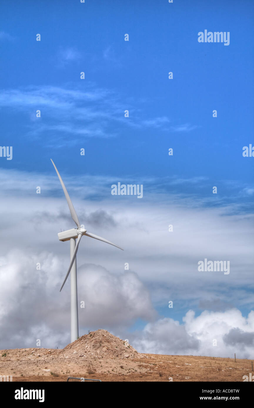 Image of a wind mill generating electricity at a wind farm against a ...