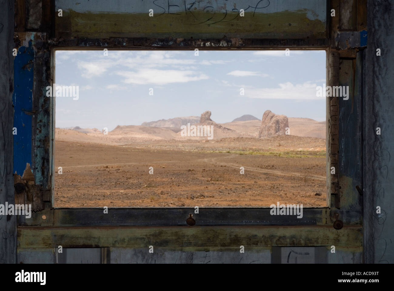A window in a deserted hut on the road to Assekrem frames a spectacular ...