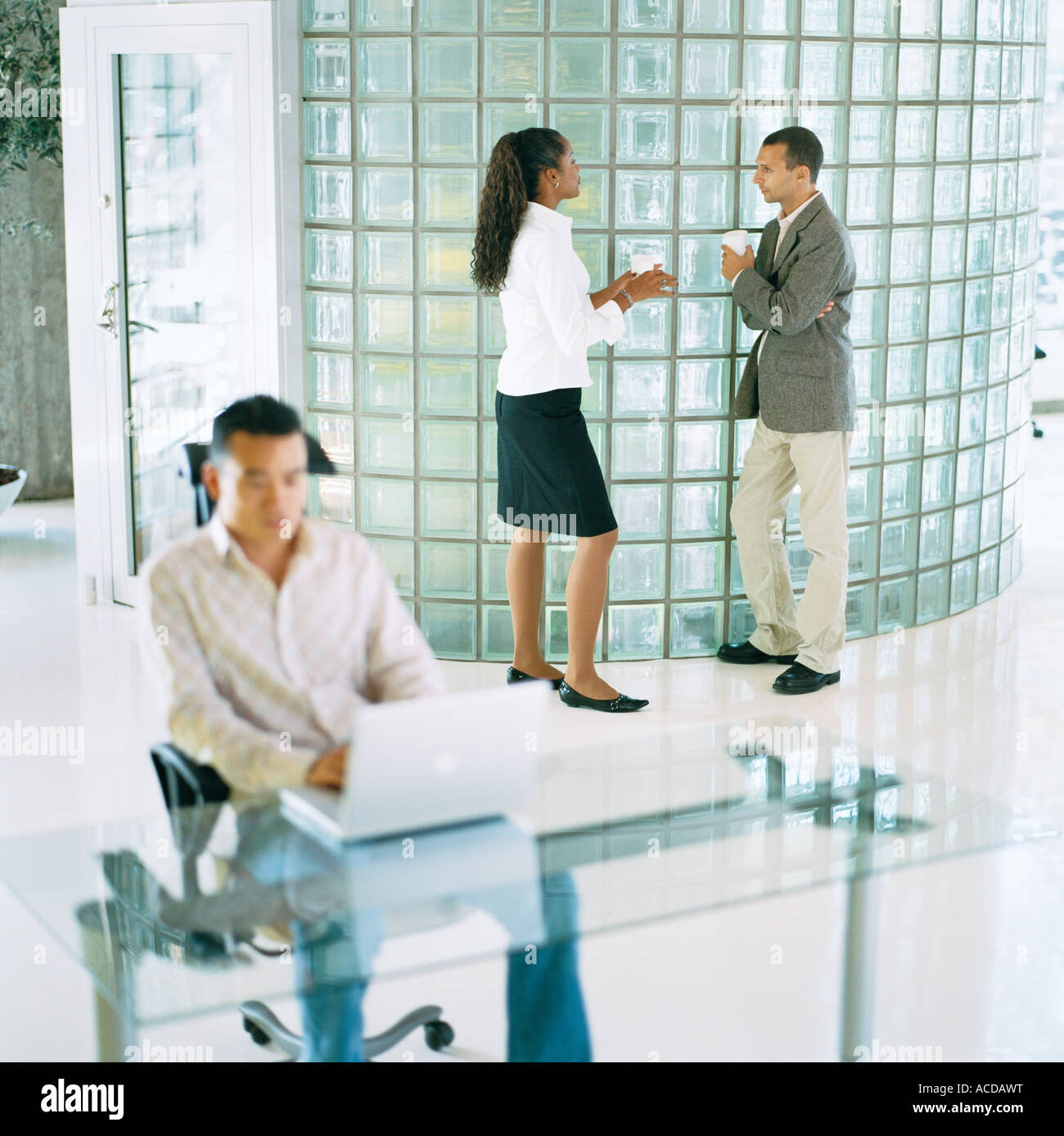 Three people in an office Stock Photo - Alamy