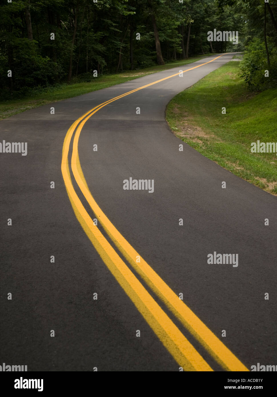 Yellow lines in the middle of a country road Stock Photo - Alamy