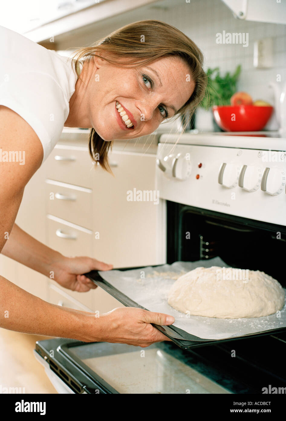 A woman baking bread in a kitchen Stock Photo - Alamy