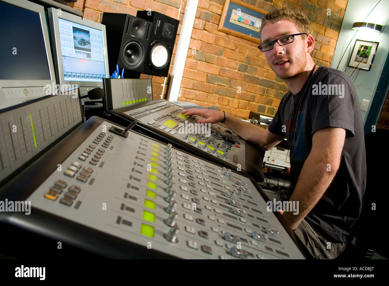 young man mixing at sound desk console mixer in recording studio Stock ...
