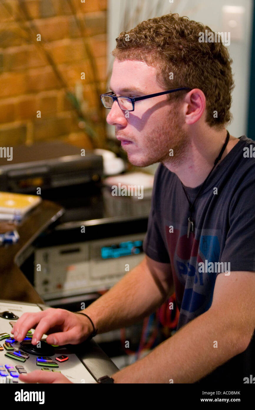 young man mixing at sound desk console mixer in recording studio Stock ...