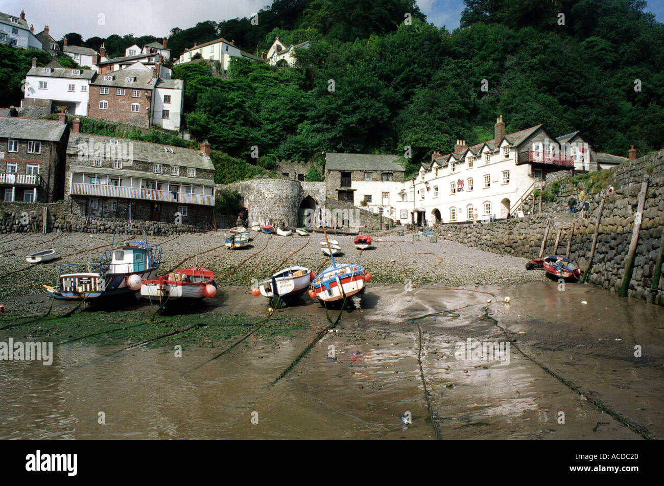 Boats behind 13th century harbour wall in Clovelly North Devon England ...