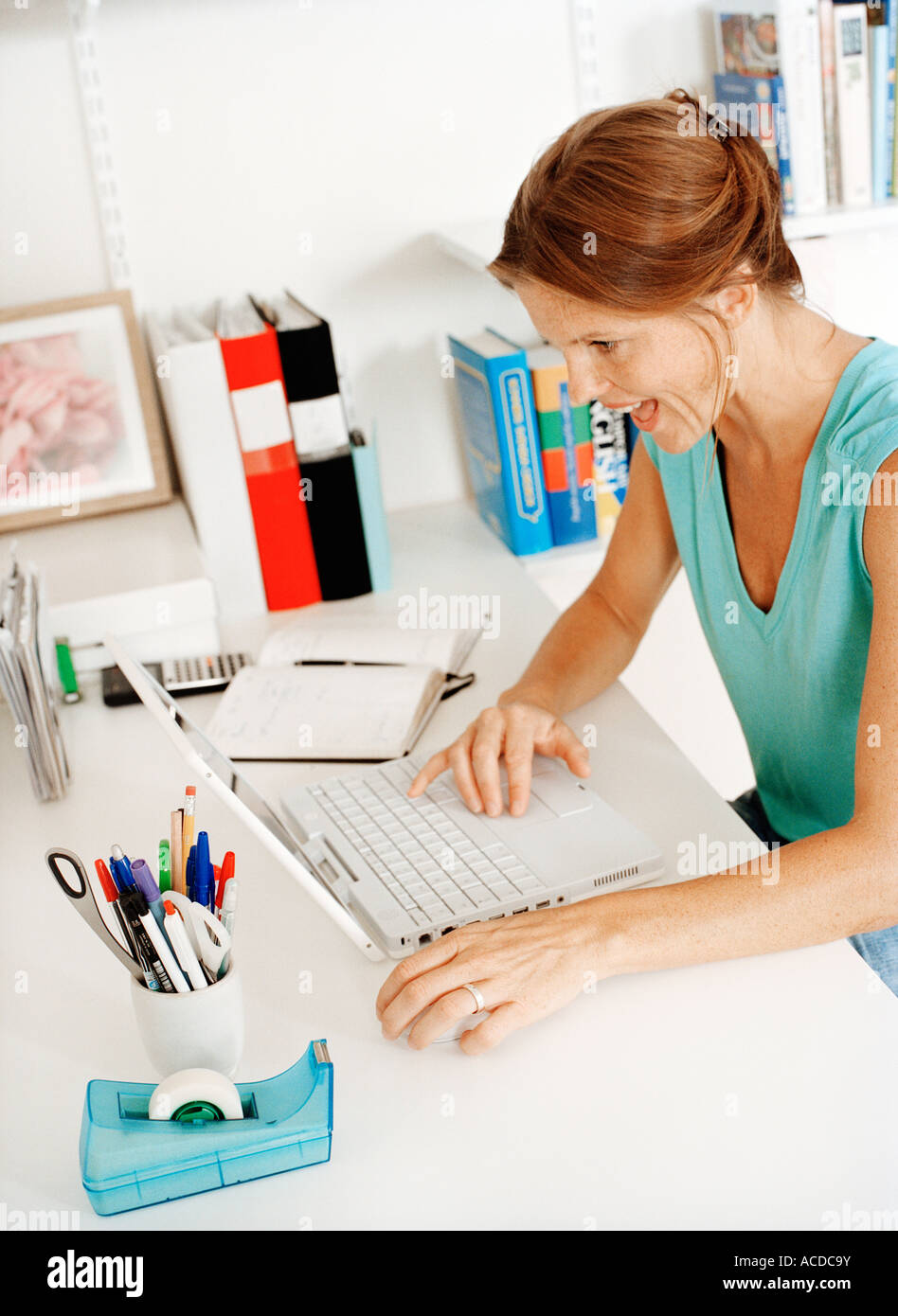 A woman working on a computer Stock Photo - Alamy