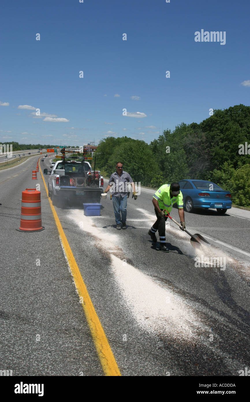 Traffic accident Tow truck workers are cleaning up spilled anti freeze ...