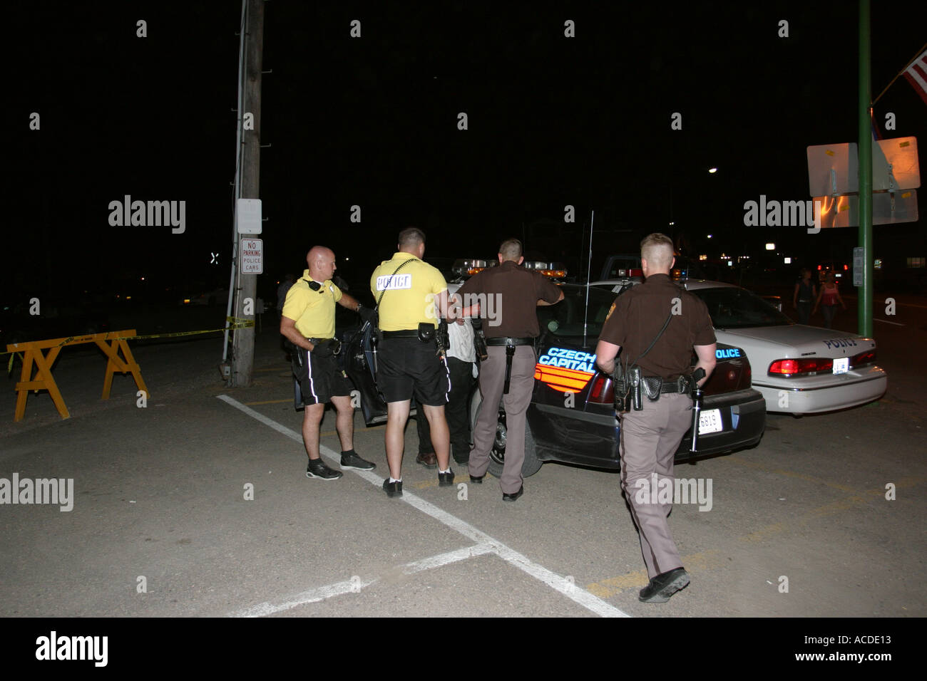 Sheriff s deupties and police officers are arresting a drunk in a rural ...