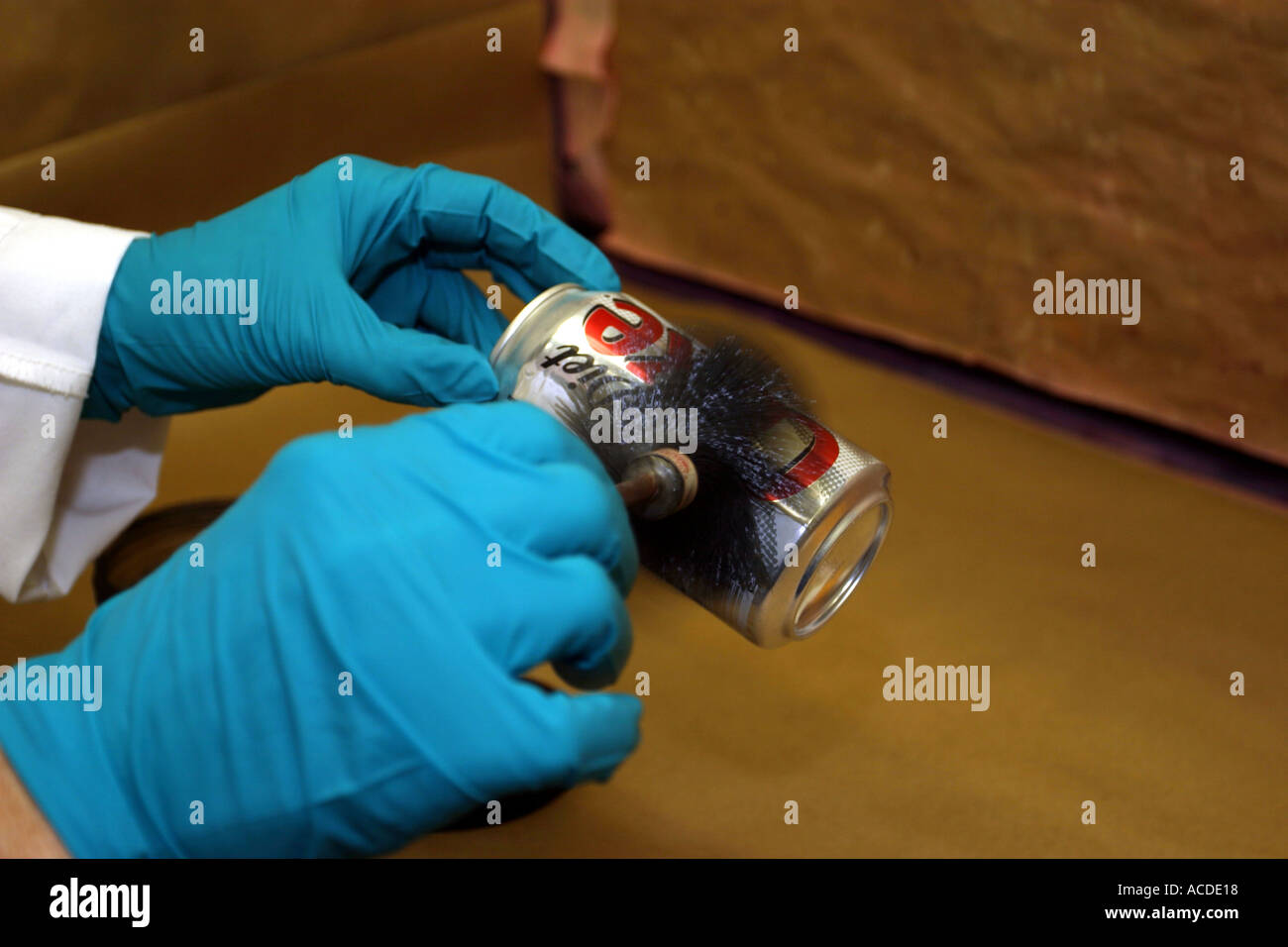 Fingerprint expert dusting aluminum can for prints. Nebraska Crime Lab ...