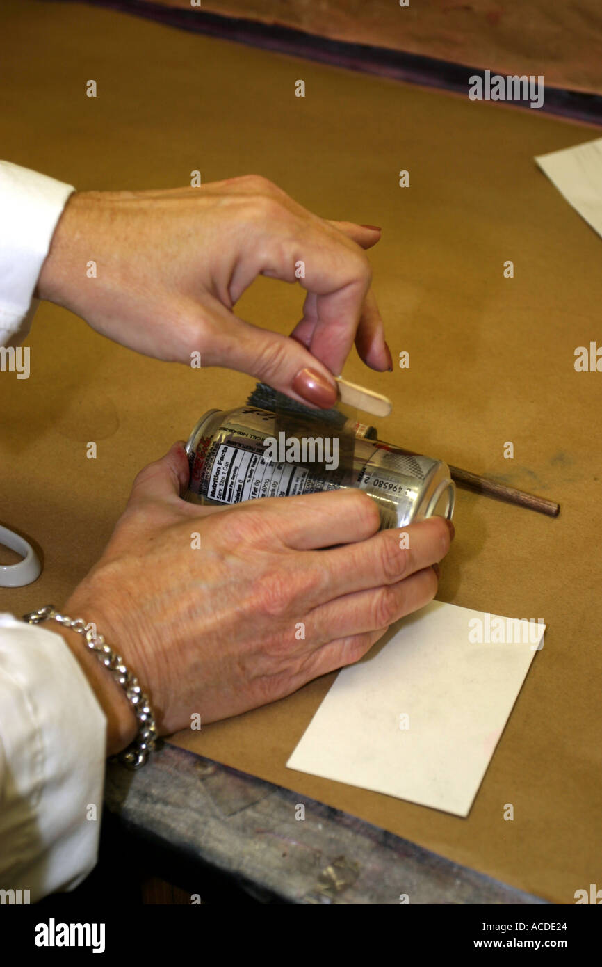 Fingerprint expert lifting print off aluminum can using lift tape ...
