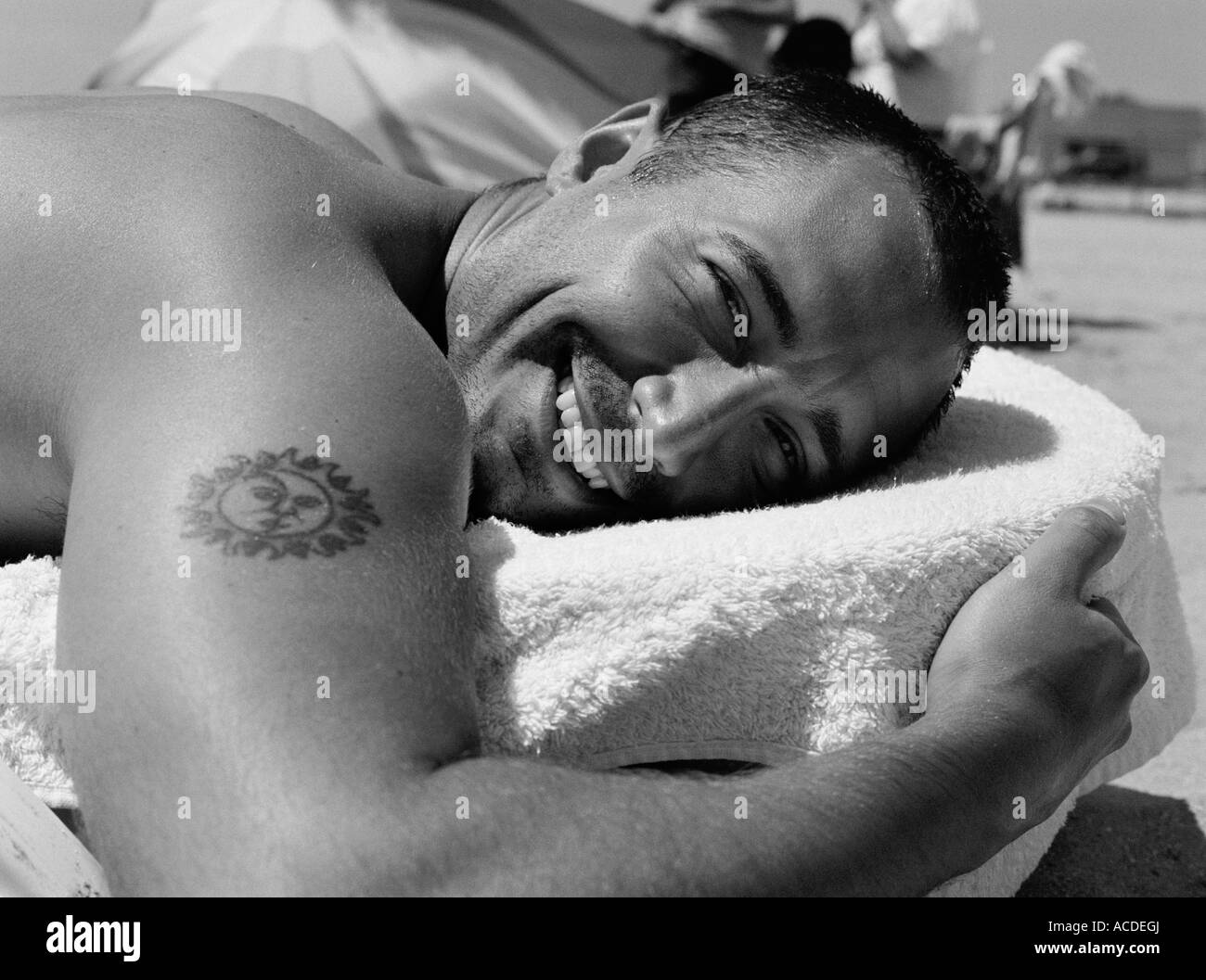 Man sunbathing on towel hi-res stock photography and images - Alamy