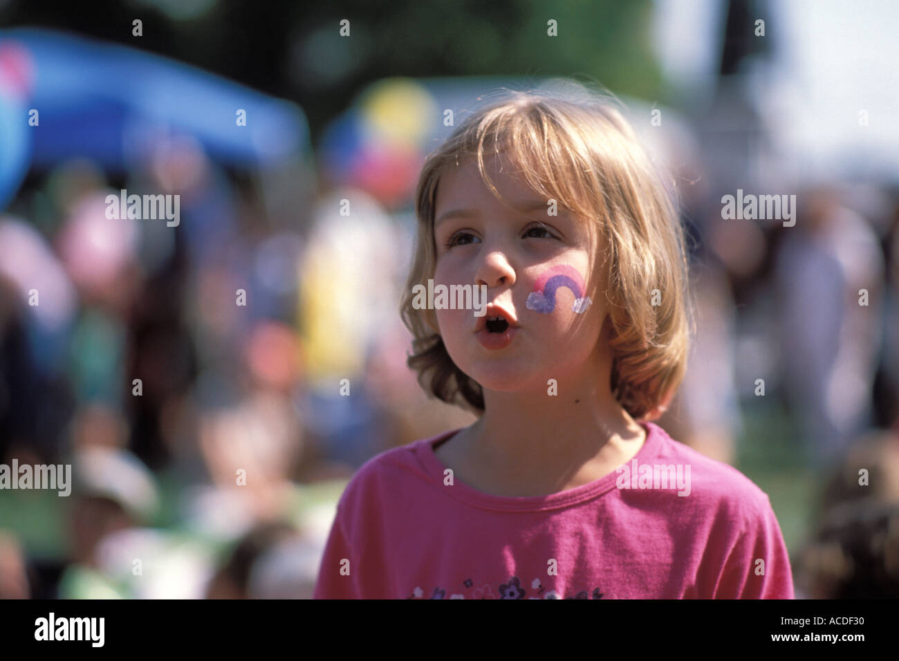 Young girl watching a performer at a children's concert in Canada Stock ...
