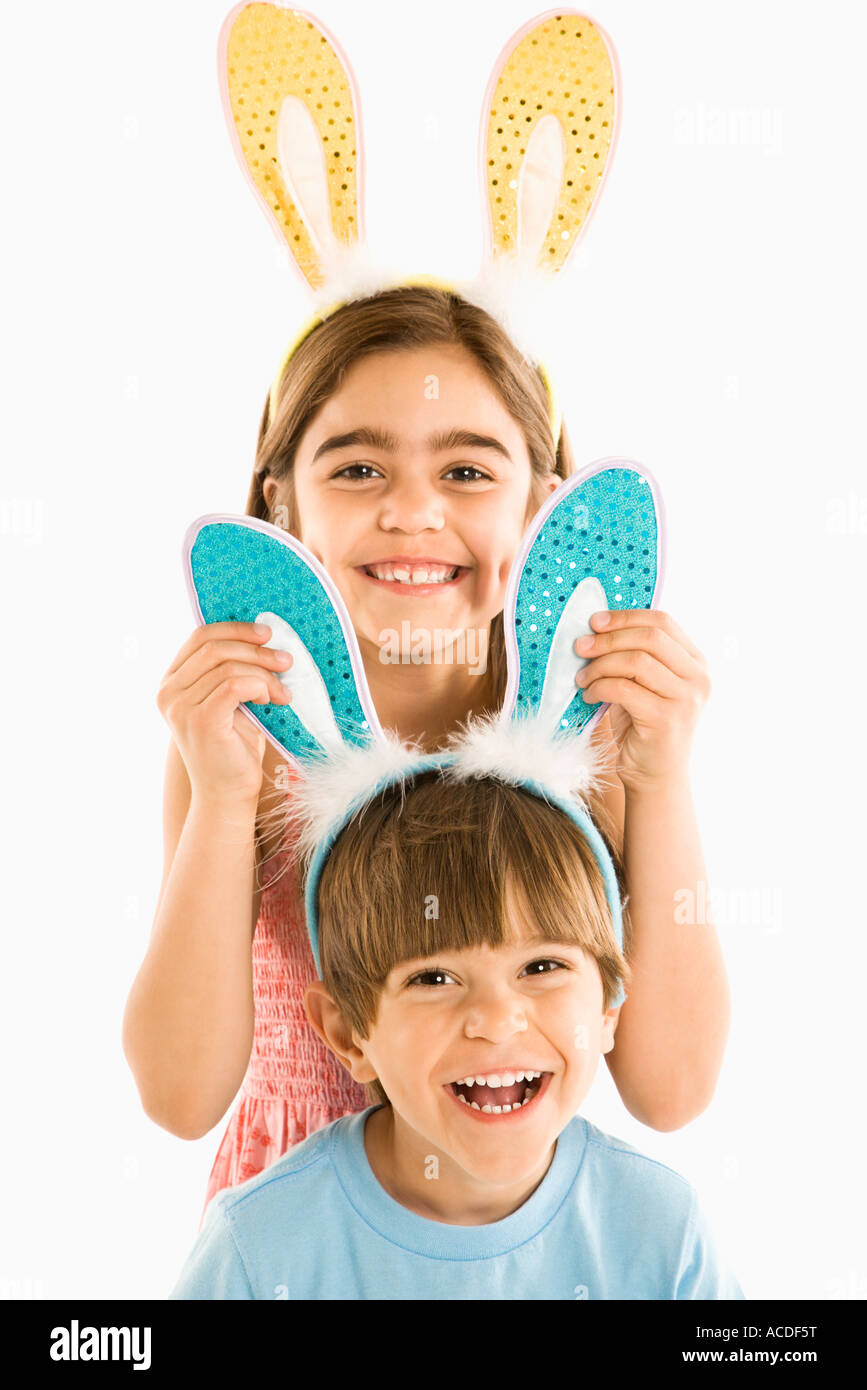 Portrait of boy and girl wearing rabbit ears smiling Stock Photo - Alamy