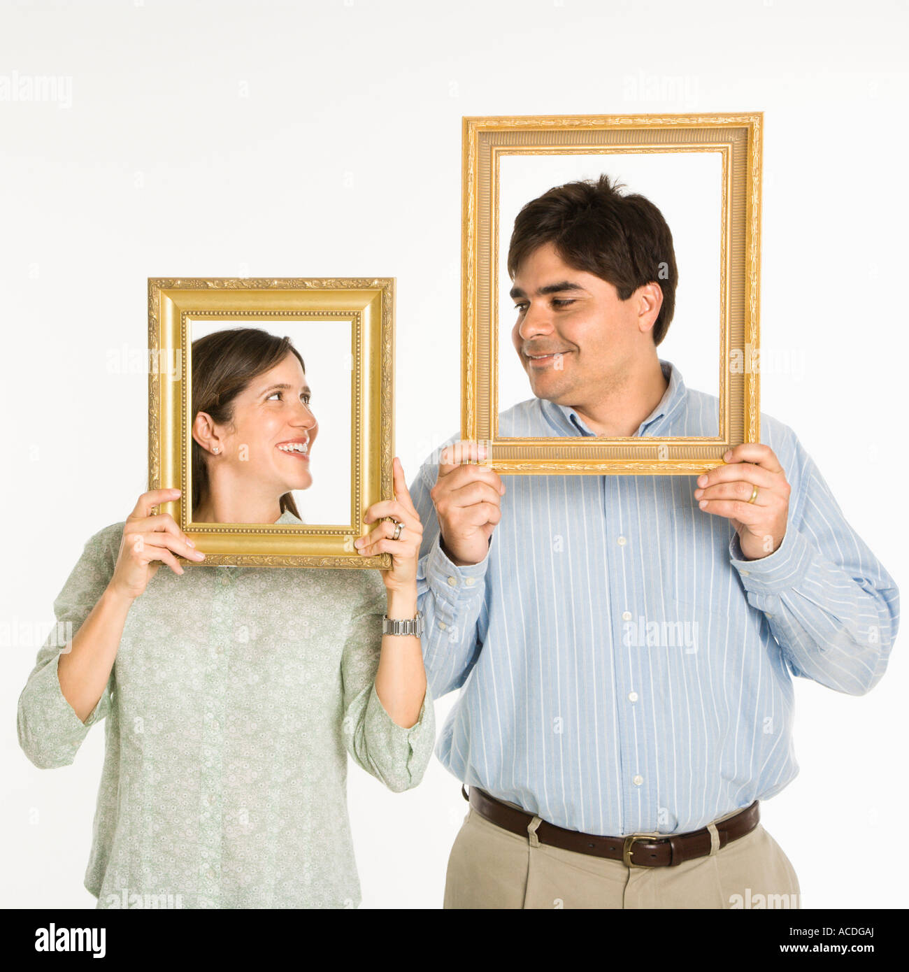 Man and woman looking through empty frames Stock Photo - Alamy