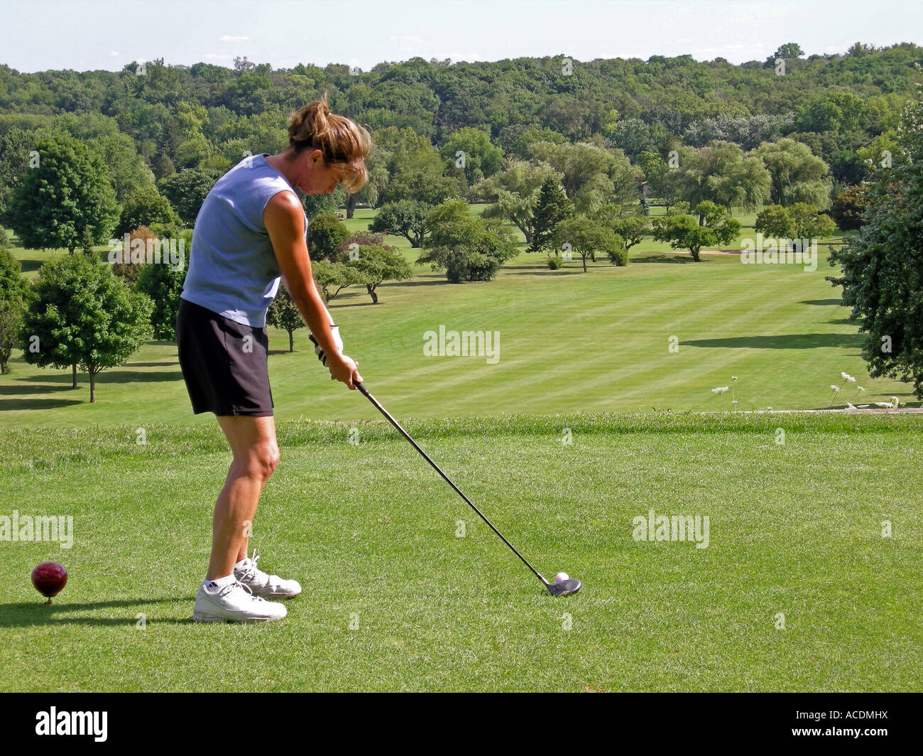 Girl Teeing Off on Golf Course Stock Photo - Alamy