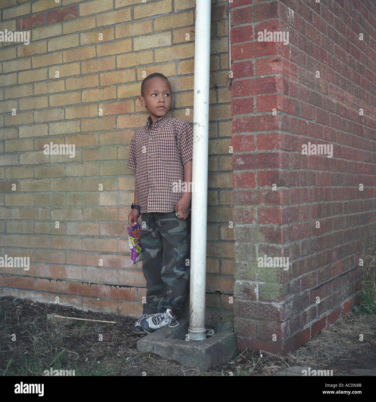 Black Boy Standing In Corner