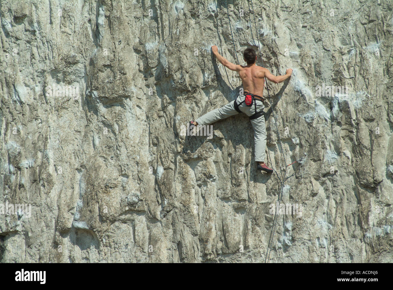 Malham cove climbers practising a climb up a vertical limestone cliff ...