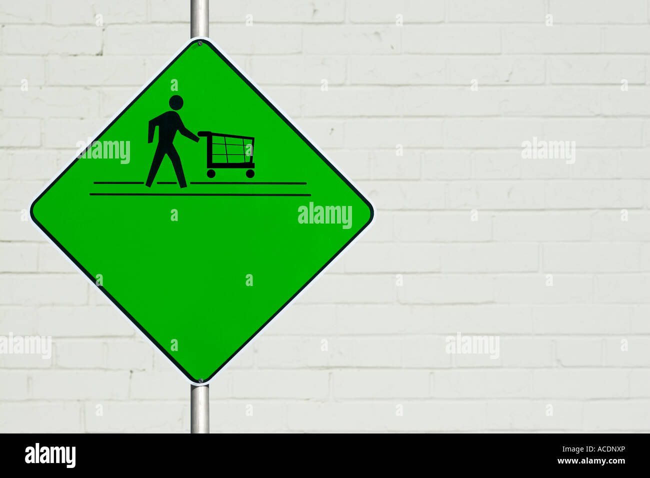 Sign with graphic of shopper pushing cart Stock Photo - Alamy