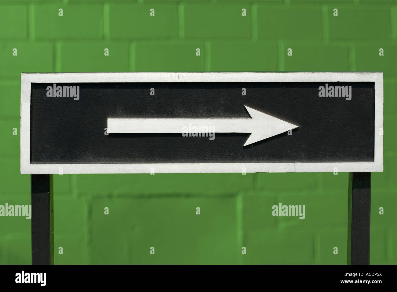Cast metal sign with arrow Stock Photo - Alamy