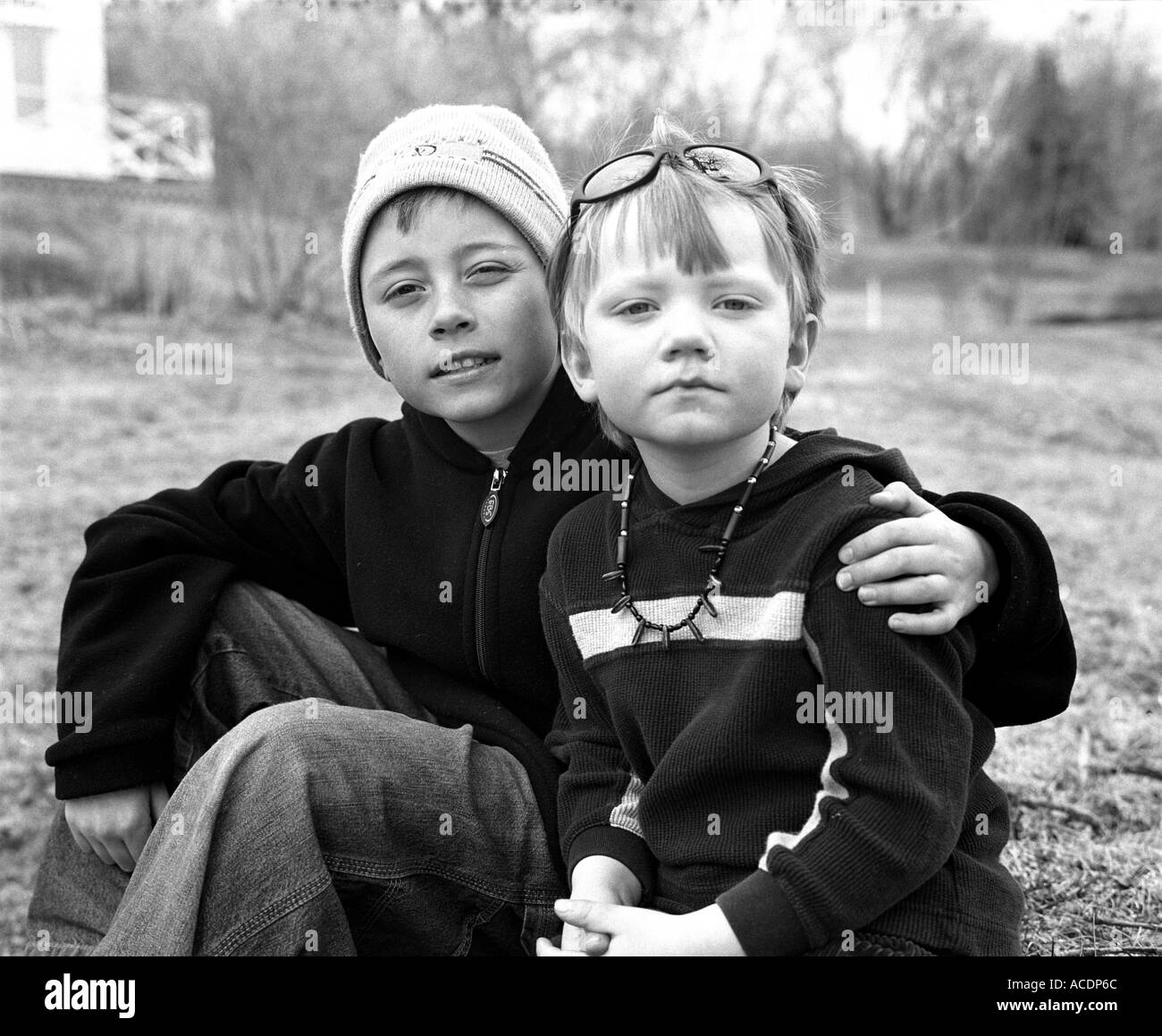 Two friends sitting together outdoors Black and White Stock Photos ...