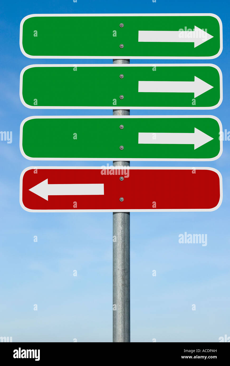 Three blank green arrow signs over blank red sign with opposite ...