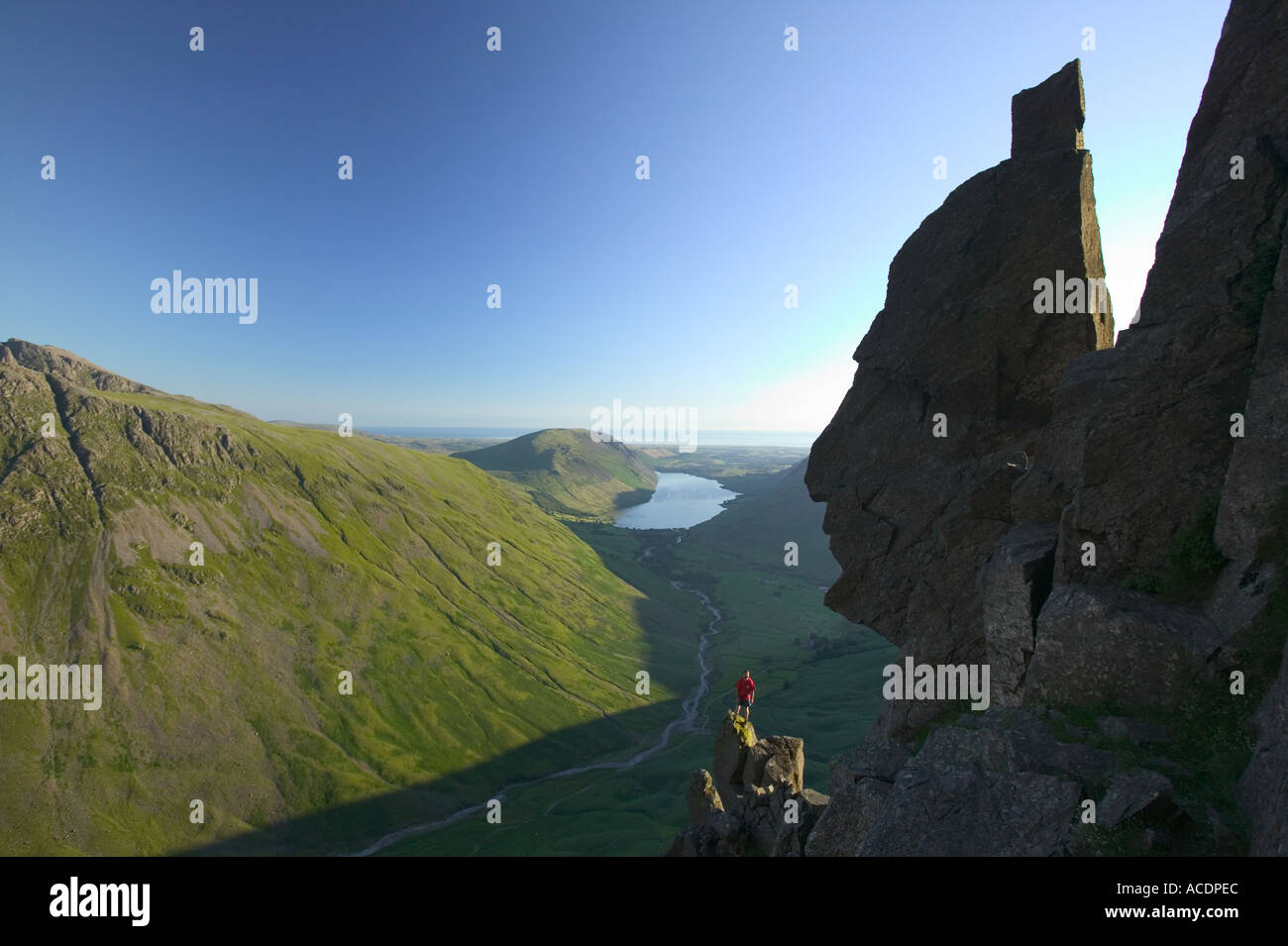 a climber below the Sphinx rock on Great Gable with Wasdale valley and ...