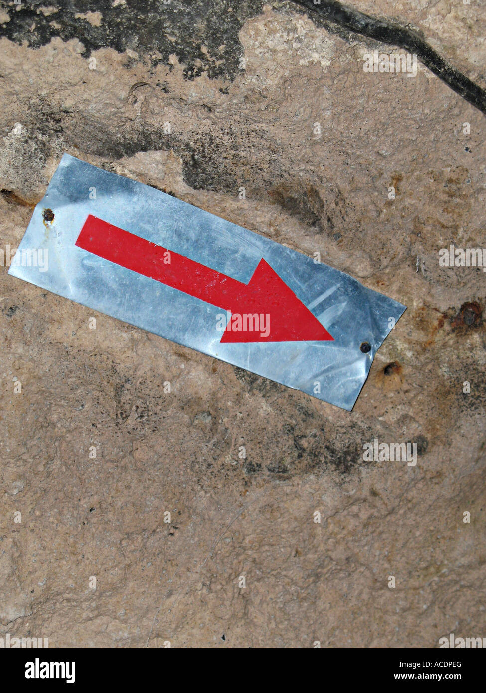 Metallic red directional arrow sign Stock Photo - Alamy