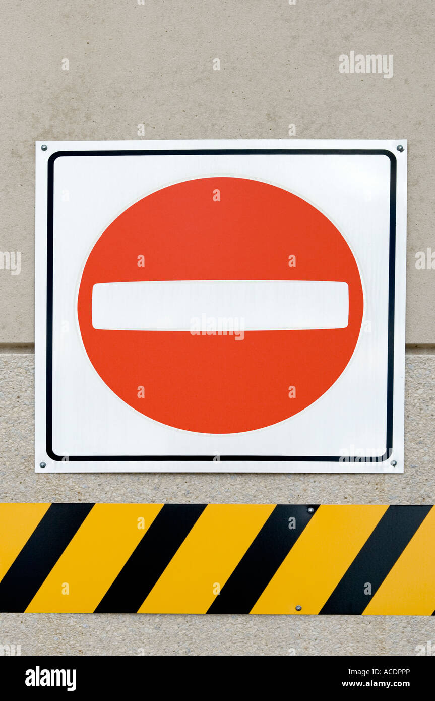 No entry sign over black and yellow striped warning sign Stock Photo ...