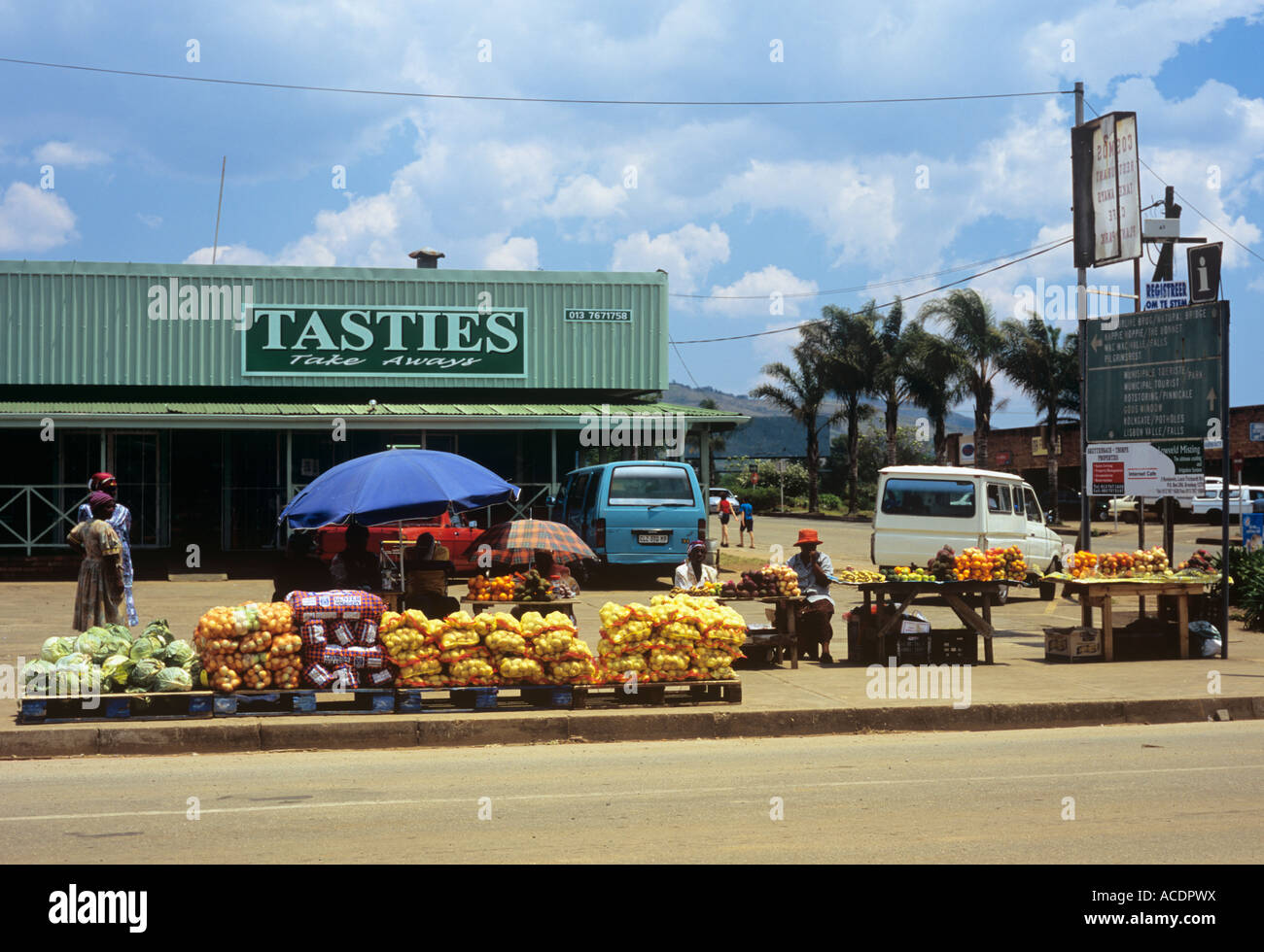 FRUIT and VEGETABLE STALLS in sun manned by black women by roadside ...