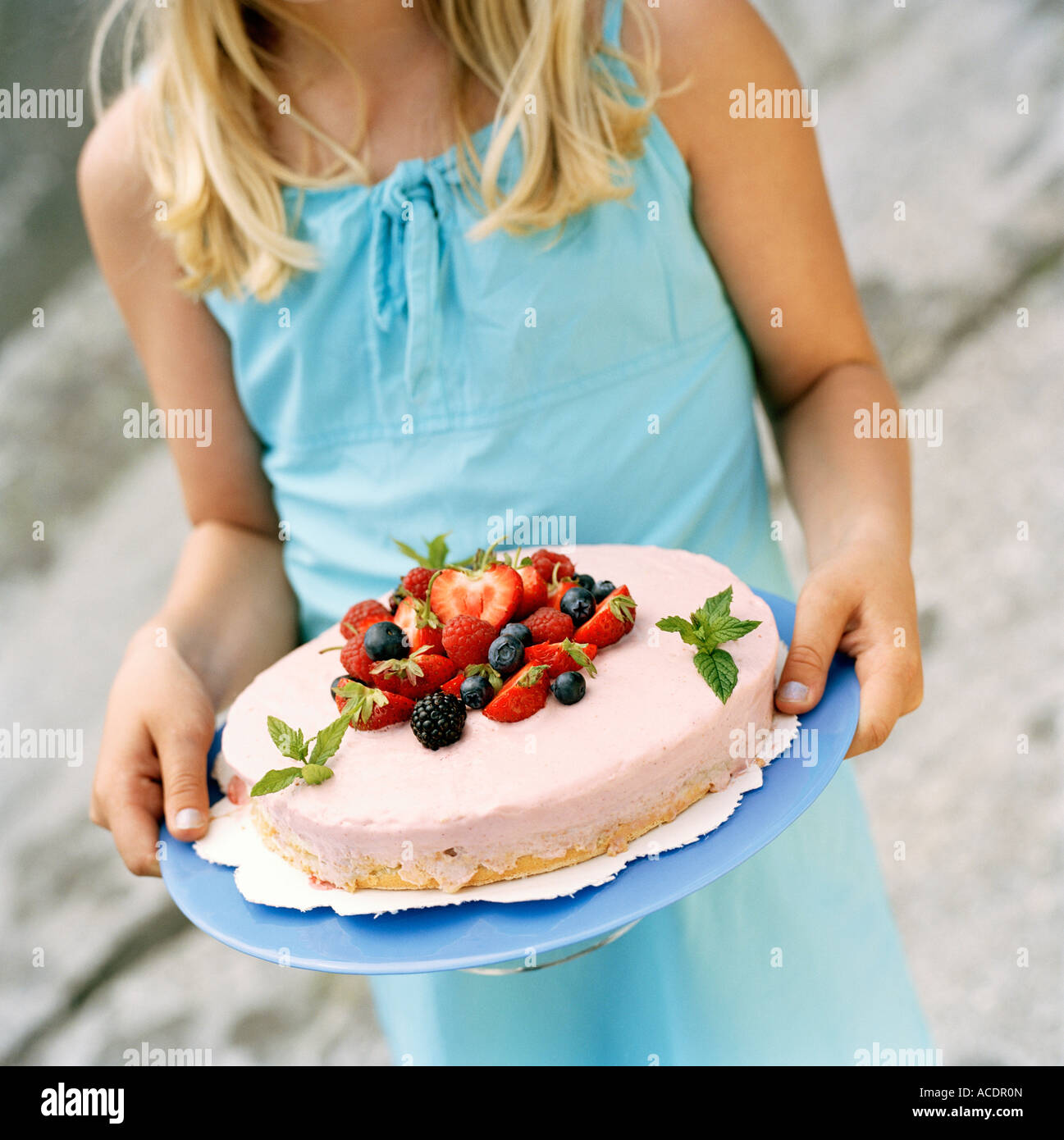 A girl holding a cake Stock Photo - Alamy