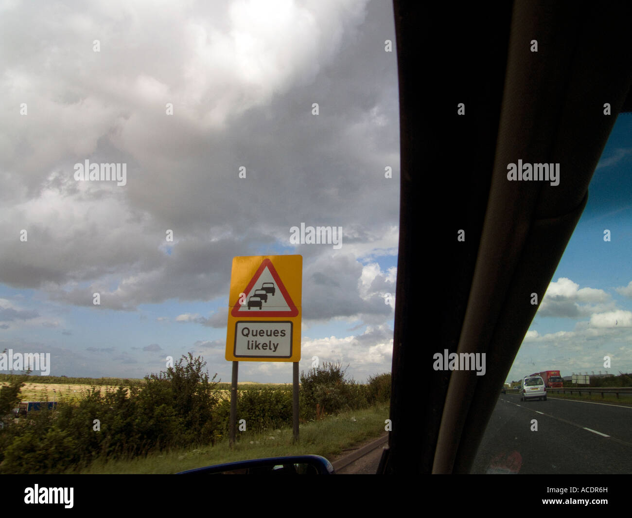 Queues likely sign seen from the interior of a passing car Stock Photo ...