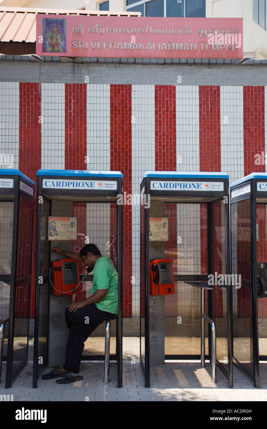 Indian man using Singapore Telecom cardphone phone booth by Sri ...