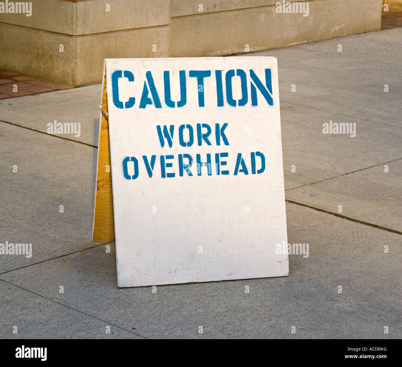 Caution - Work Overhead sign on sidewalk Stock Photo - Alamy