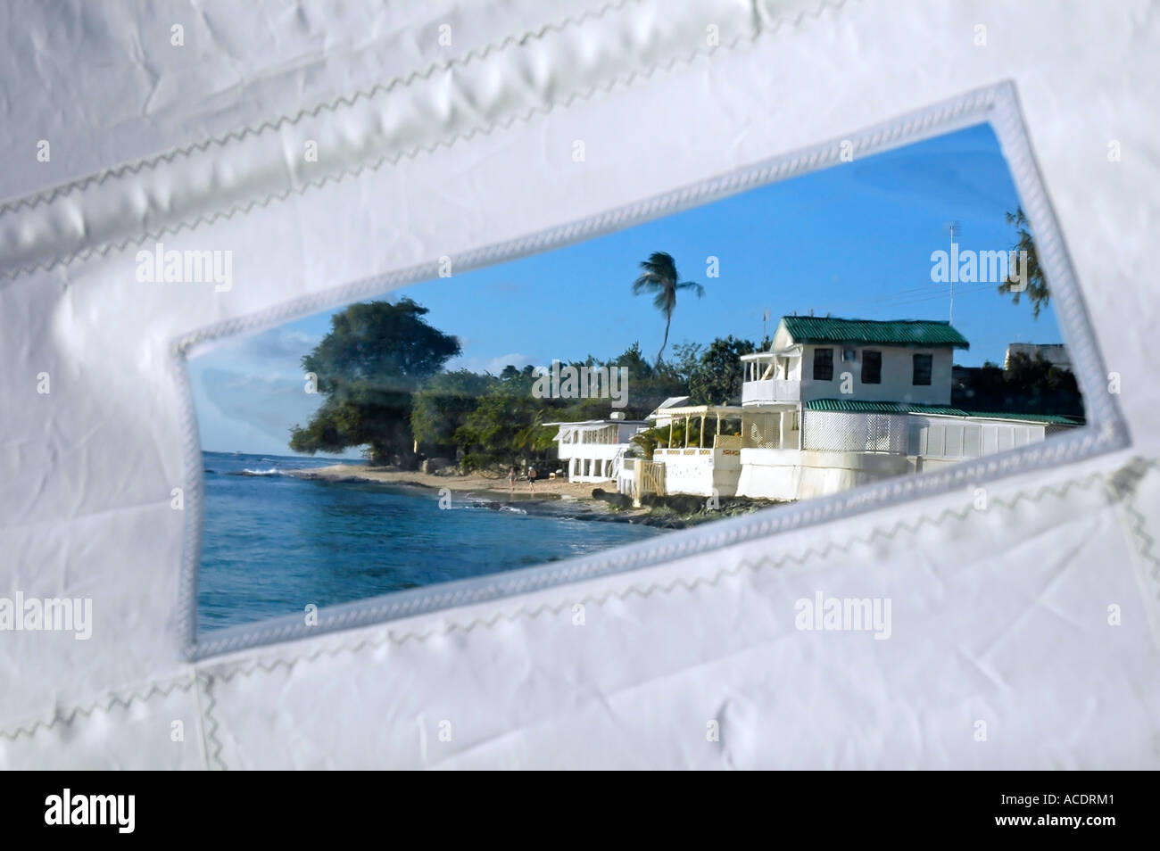 Barbados shore seen trough a small window of a sail Stock Photo - Alamy