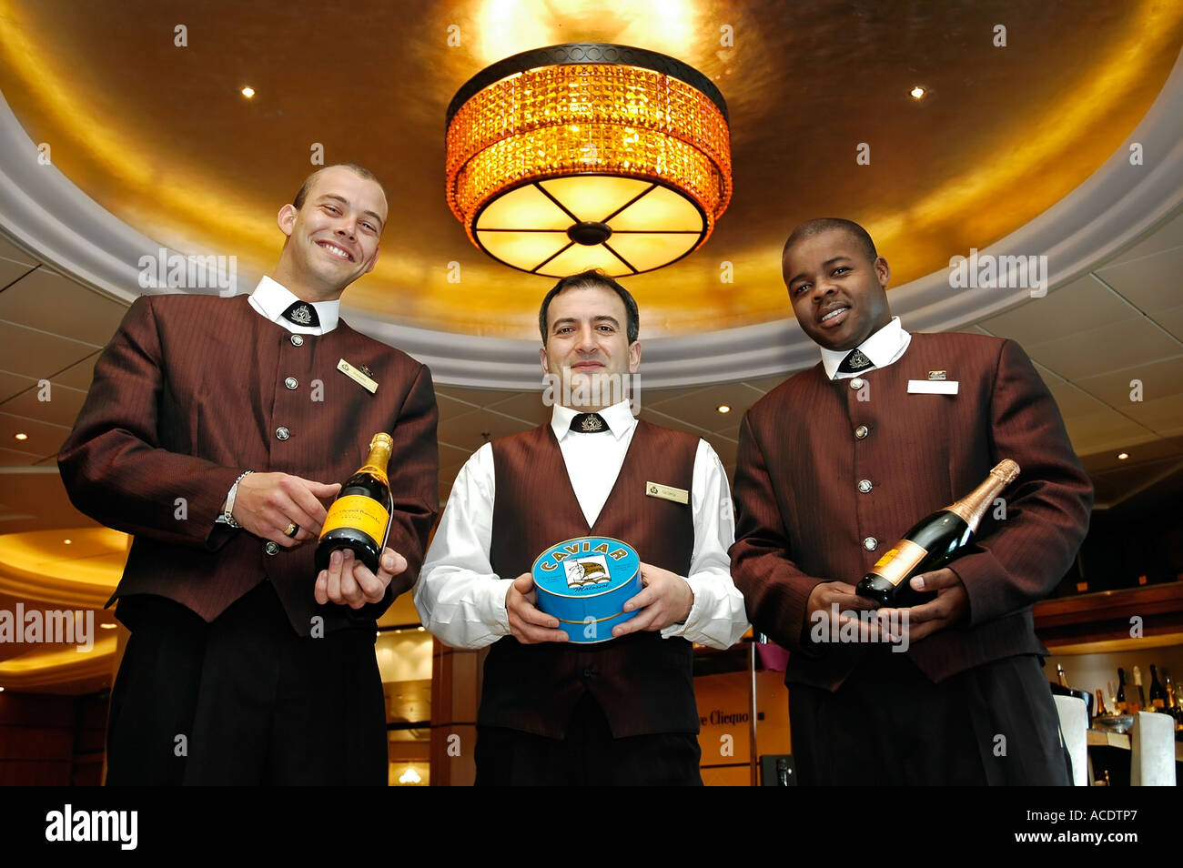wine waiters presenting champagne and caviar on board cruise ship Queen ...